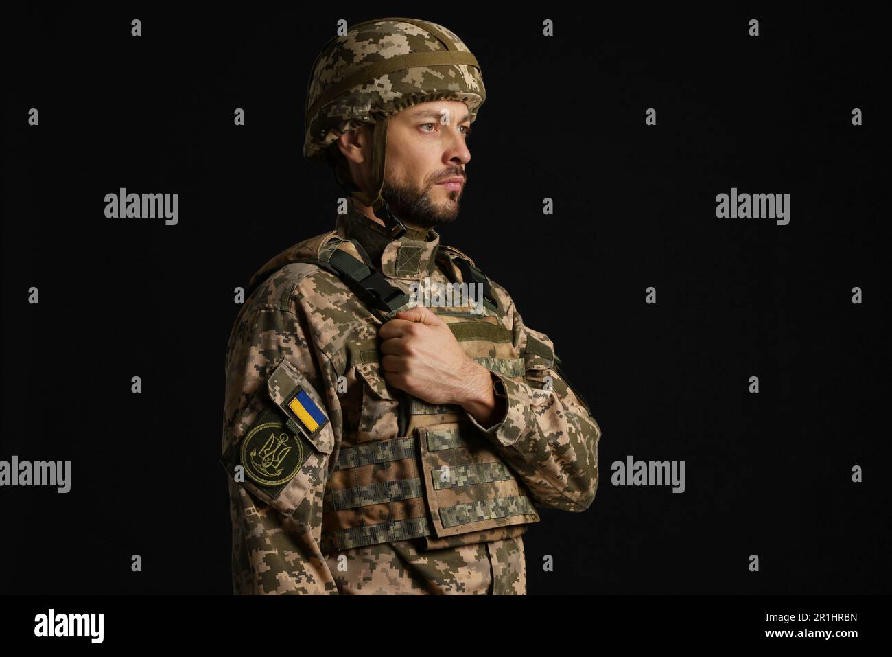 Soldier in Ukrainian military uniform on black background Stock Photo ...
