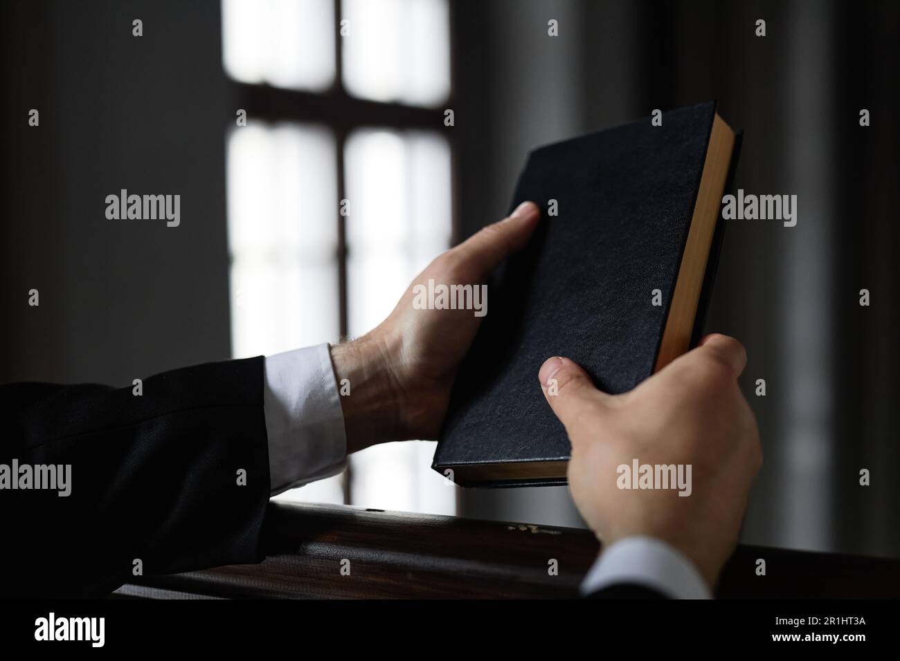 Close-up of priest holding Bible during praying in church Stock Photo ...