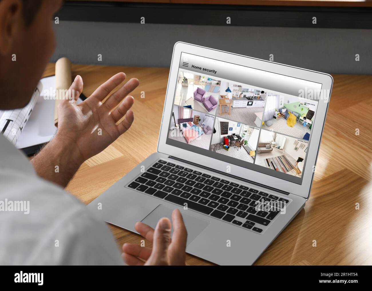 Man monitoring CCTV cameras at table, closeup. Smart home security ...