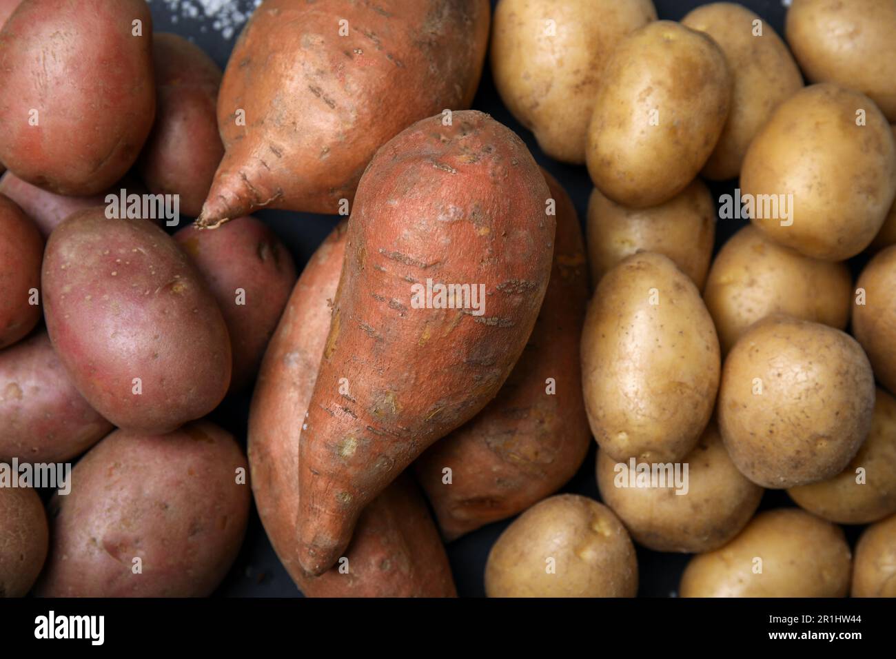 Different types of fresh potatoes as background, top view Stock Photo ...