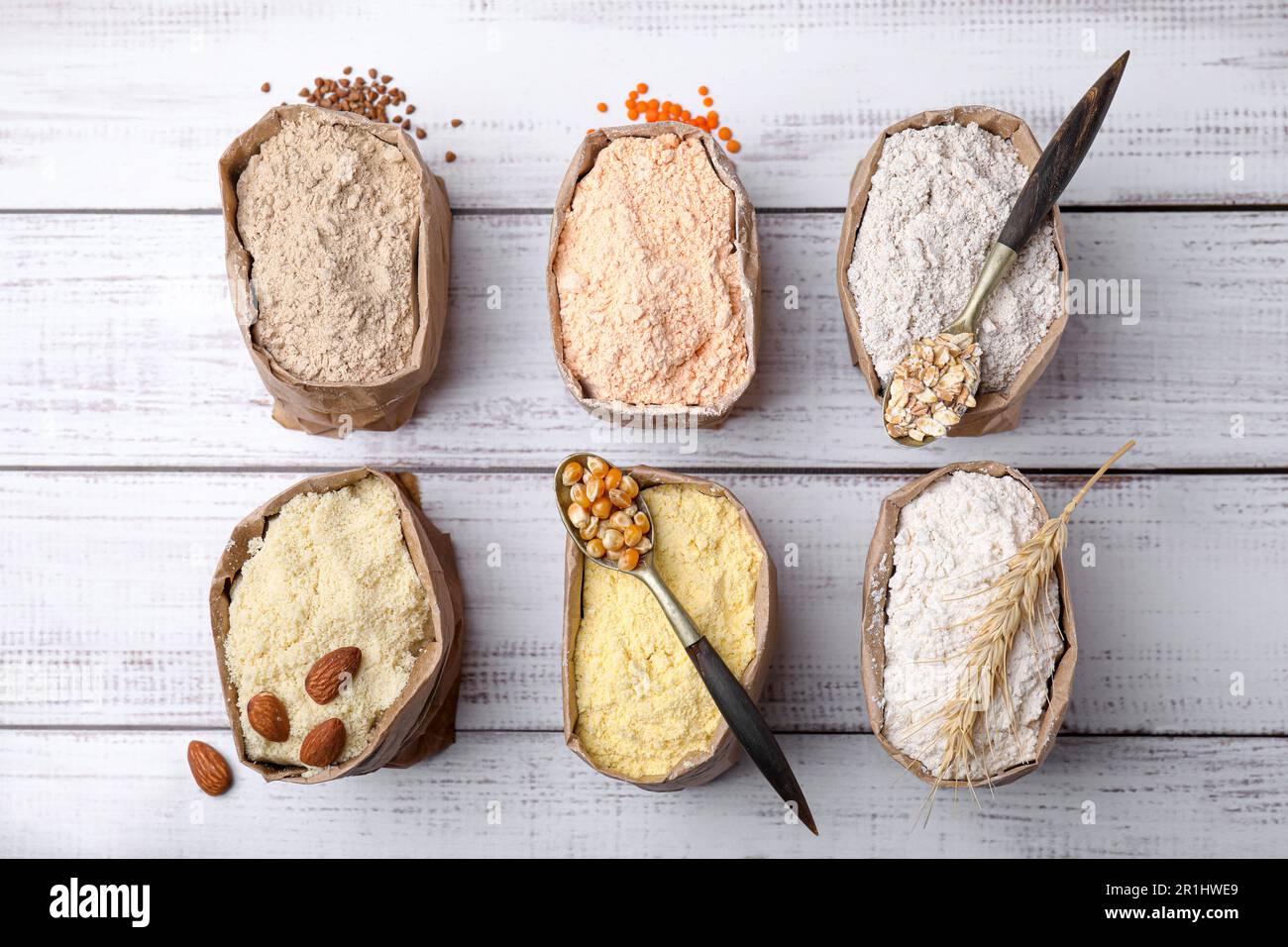 Flat lay composition with different types of flour on white wooden ...