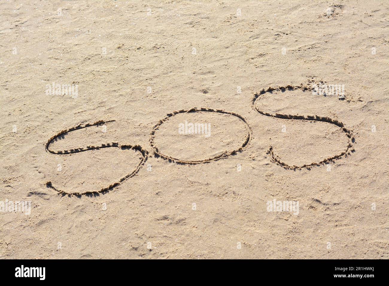 Sos message written on sand hi-res stock photography and images - Alamy
