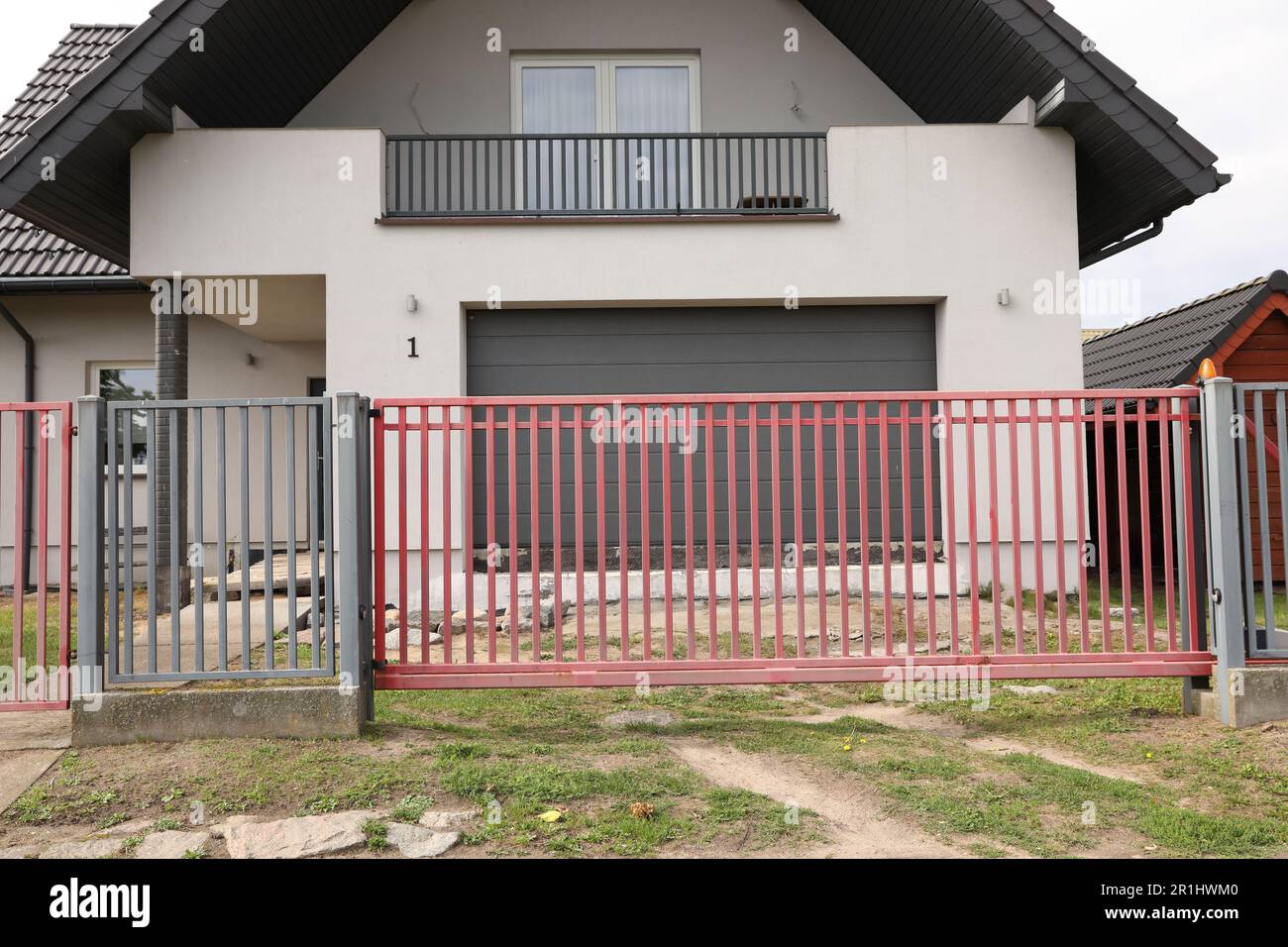 Red and grey metal gates near private house on street Stock Photo - Alamy