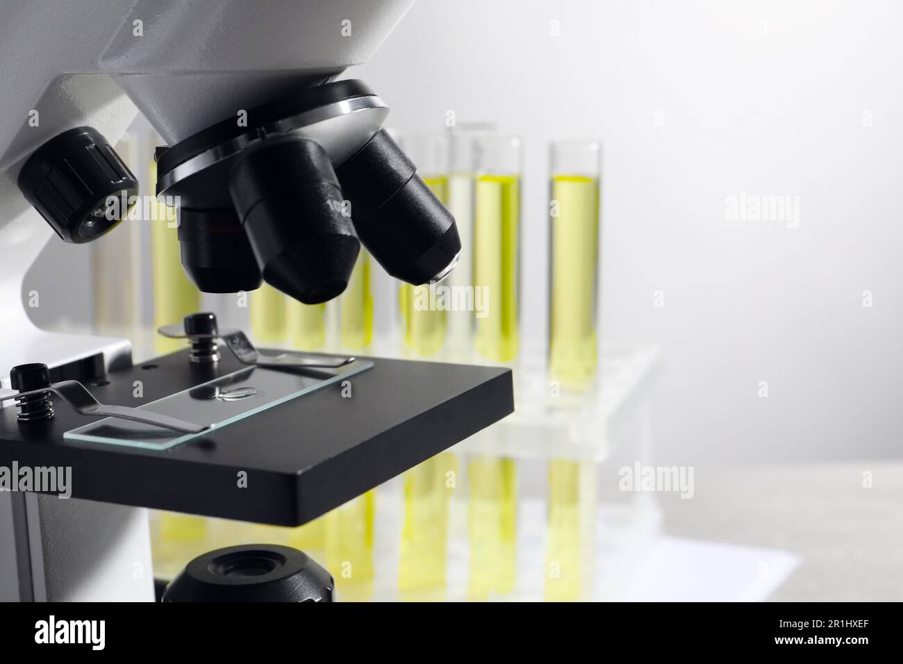 Microscope with drop of urine on glass slide in laboratory, space for ...