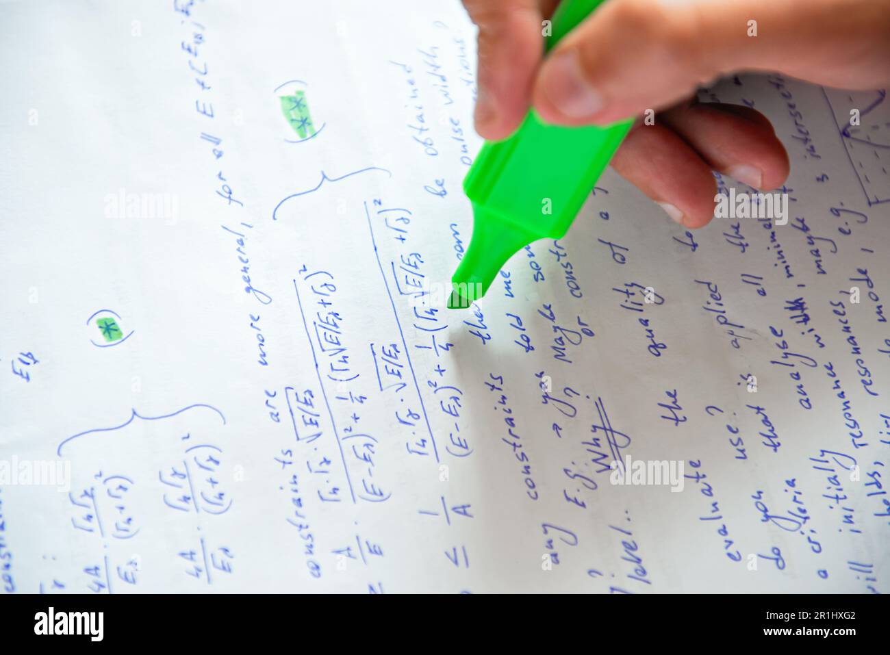 Student highlighting with green marker mathematical calculations ...