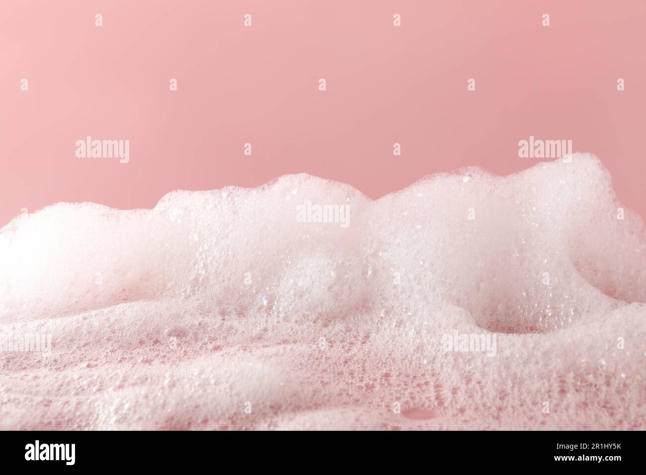 Fluffy bath foam on pink background, closeup. Care product Stock Photo ...