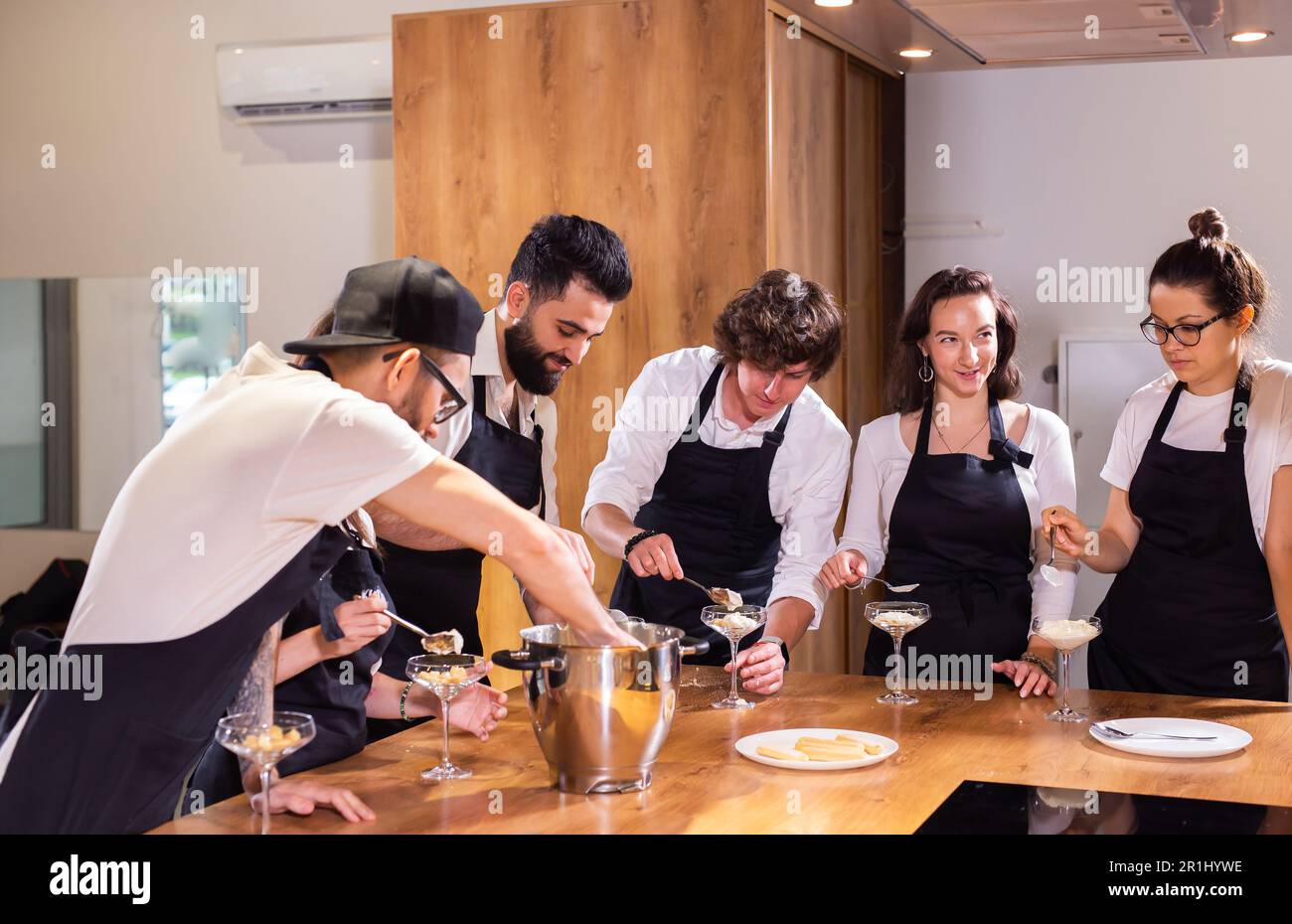 Chef teaching trainees how to make ice cream. Cooking tasty ice cream ...