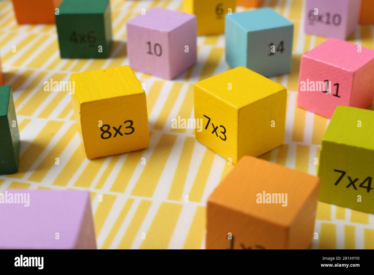 Colorful cubes with numbers and multiplications on yellow background ...