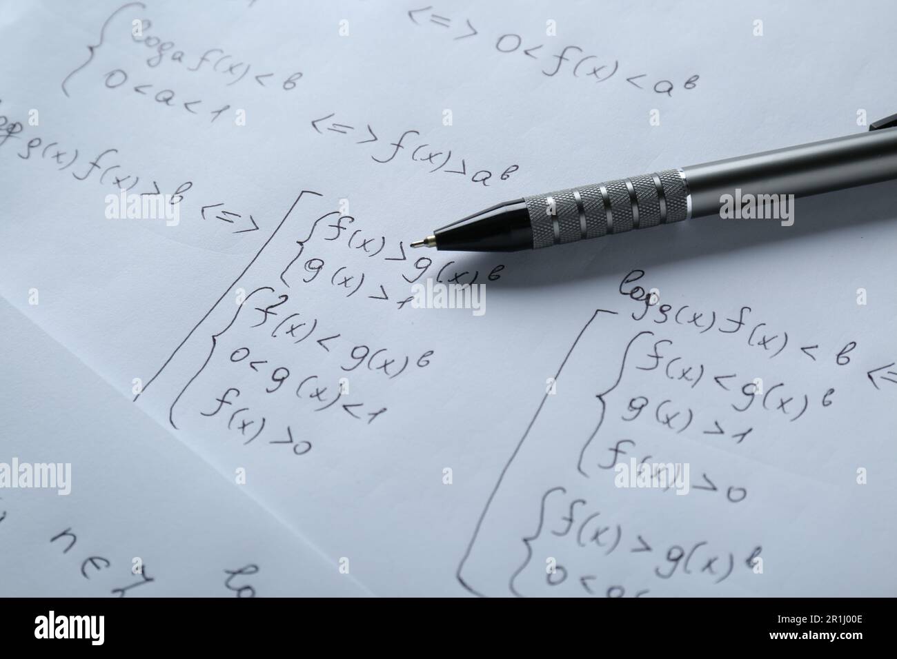 Sheets of paper with different mathematical formulas and pen, closeup ...