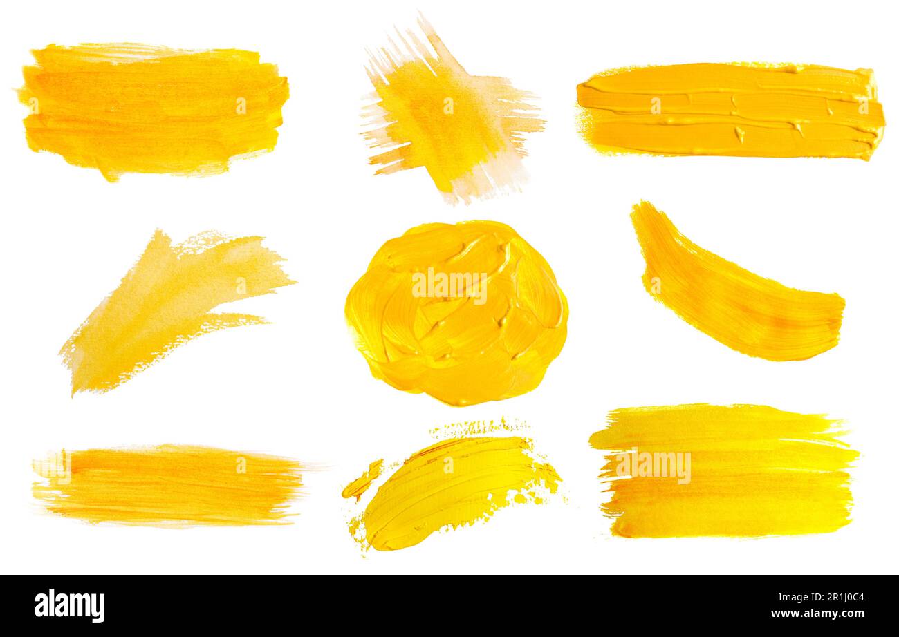 Different yellow paint strokes drawn with brush on white background ...