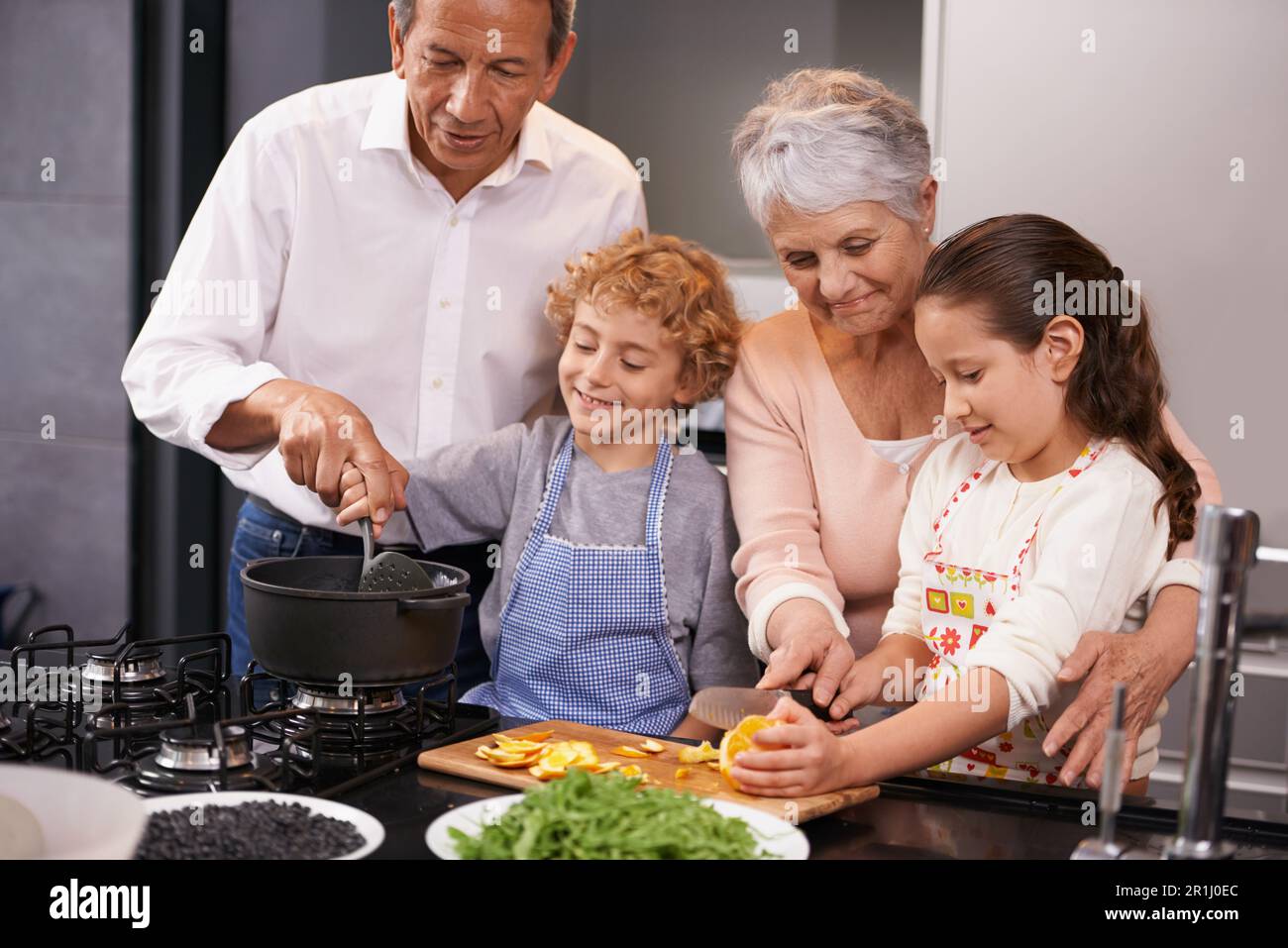 Help, happy children or grandparents teaching cooking skills for a ...