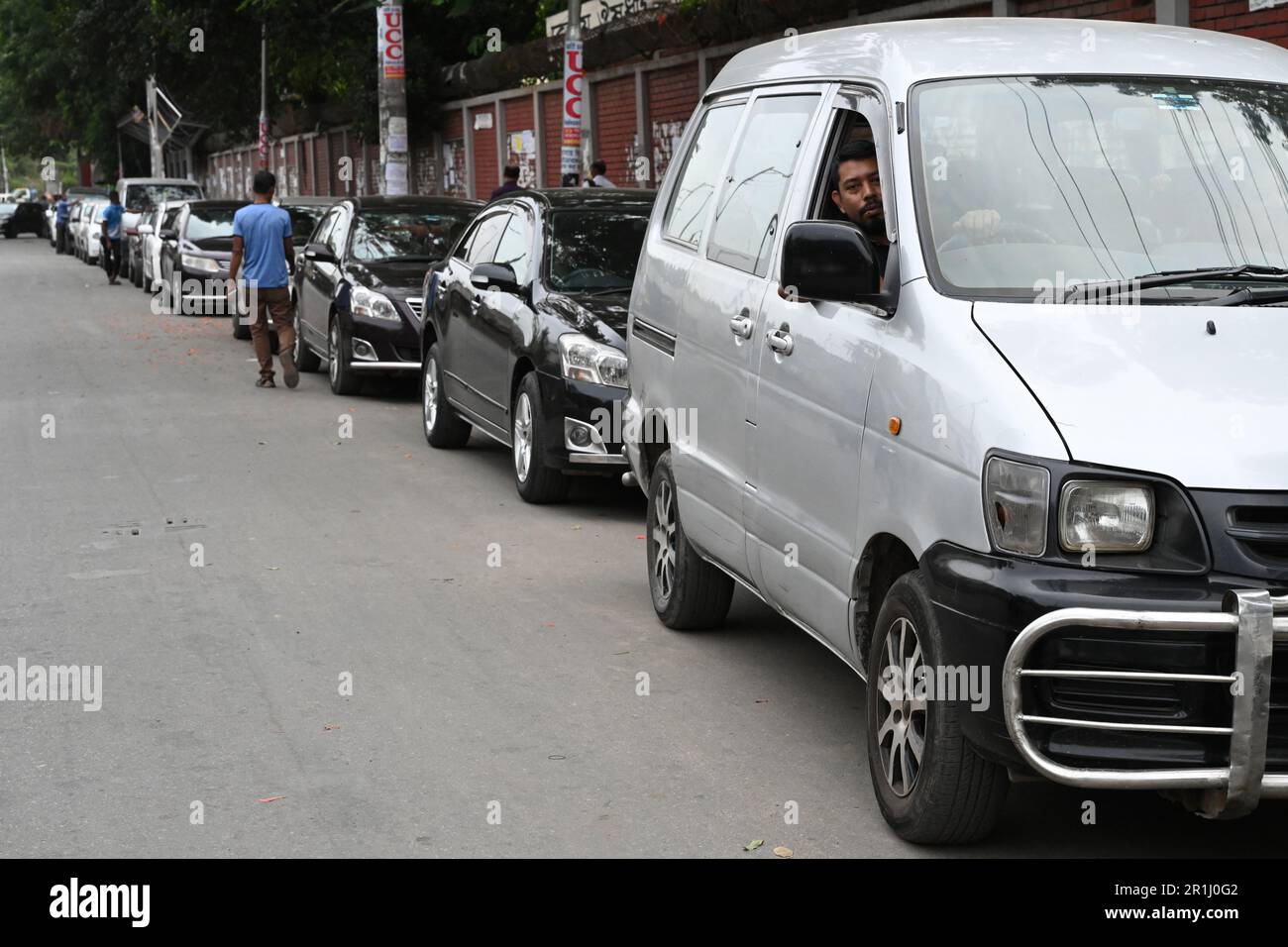 Dhaka, Bangladesh. 14th May, 2023. Vehicle drivers queue waits to ...