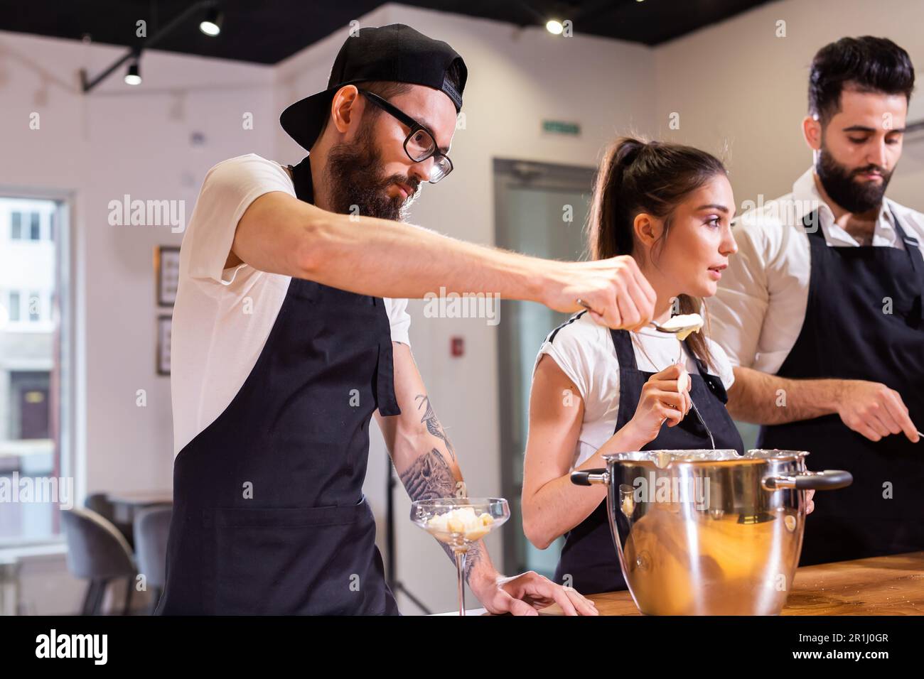 Chef teaching trainees how to make ice cream. Cooking tasty ice cream ...