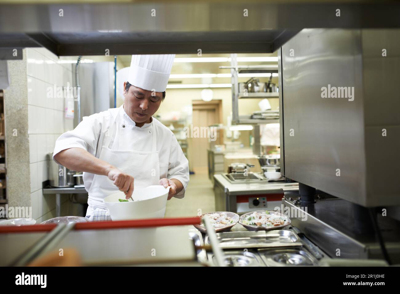 Making a gastronomic masterpiece. chefs preparing a meal service in a ...