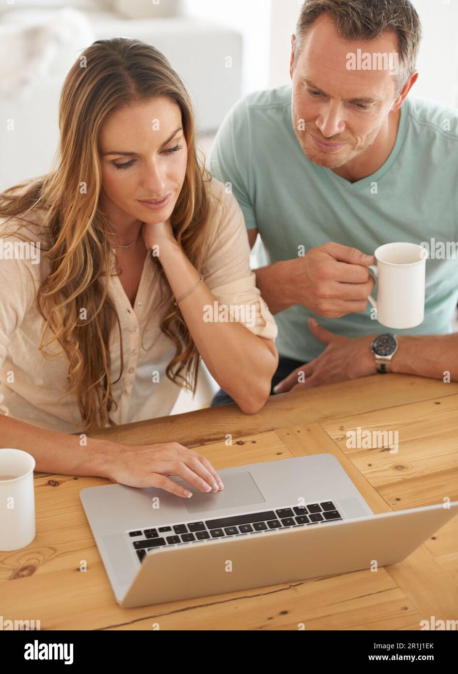 Laptop, home and couple reading online, scroll on internet together and ...