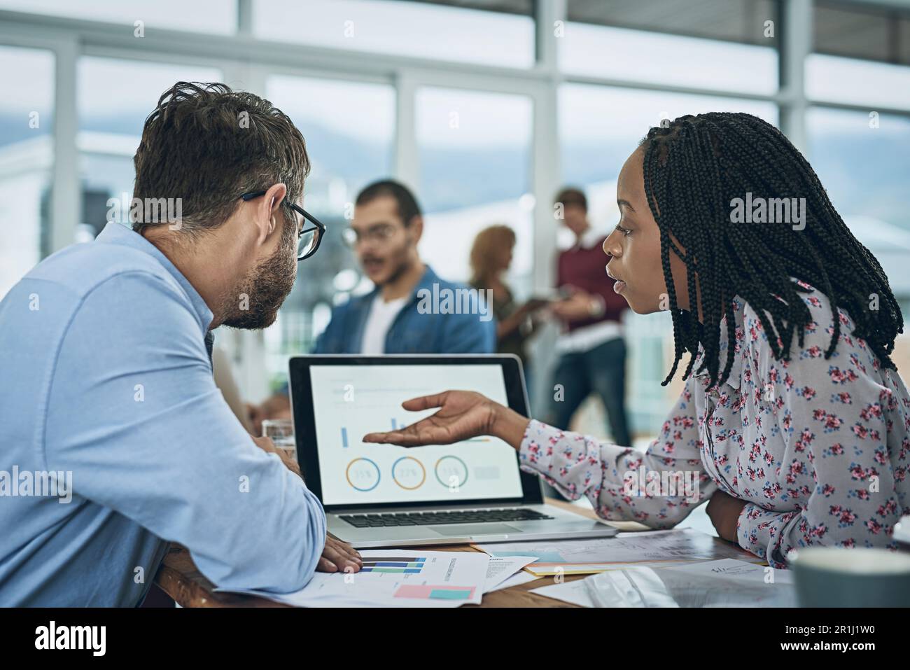Data driven discussions. two young colleagues using a laptop together ...