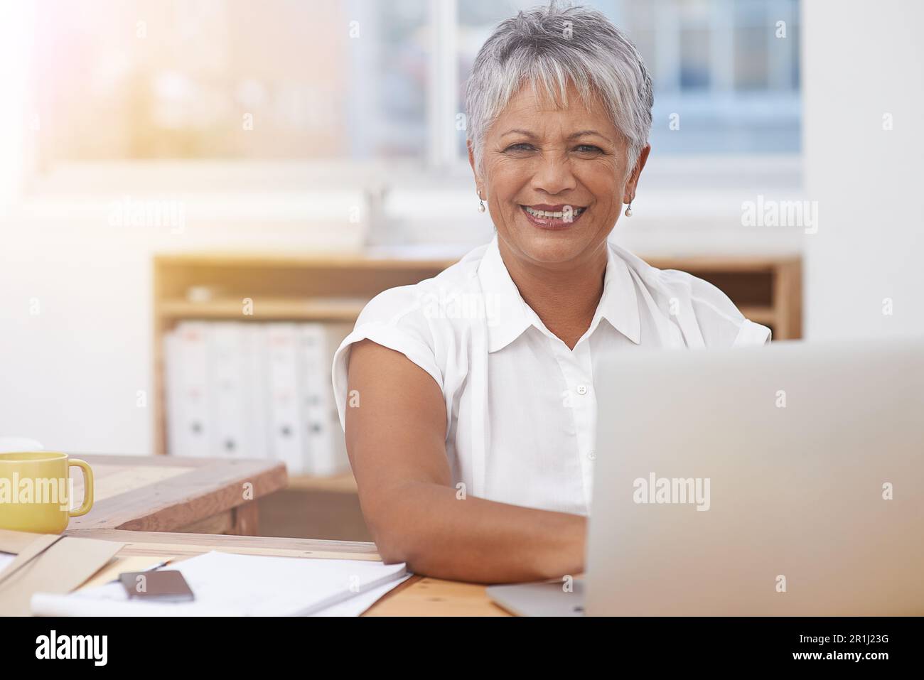 Portrait, laptop and senior woman in office smile for career management ...