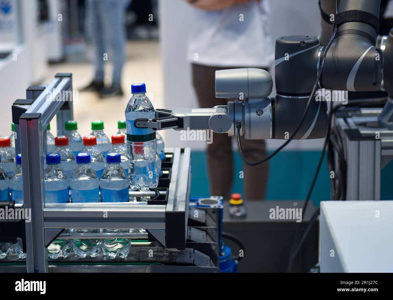 Robotic arm serving water bottles Stock Photo - Alamy