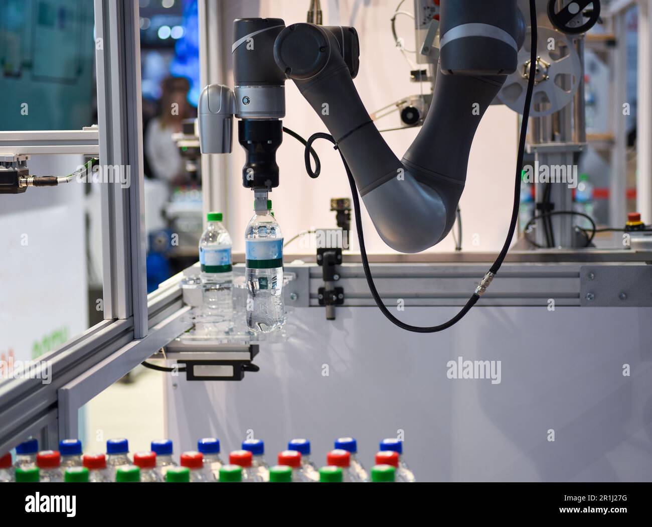 Robotic arm serving water bottles Stock Photo - Alamy