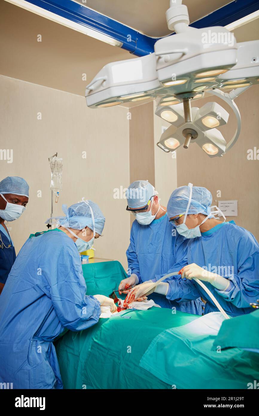 Its a medical emergency. a team of surgeons performing a surgery in an ...