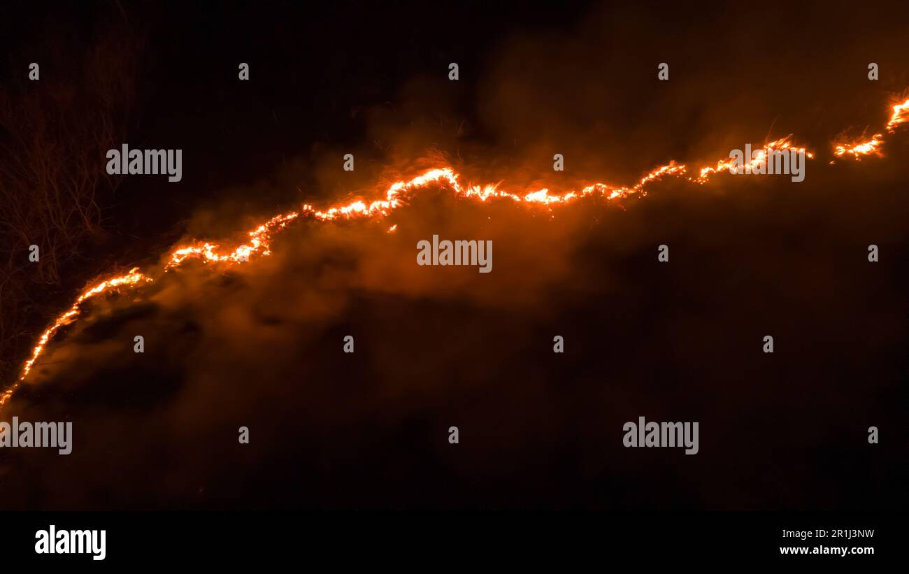 Night fire in the forest with fire and smoke.Epic aerial photo of a ...