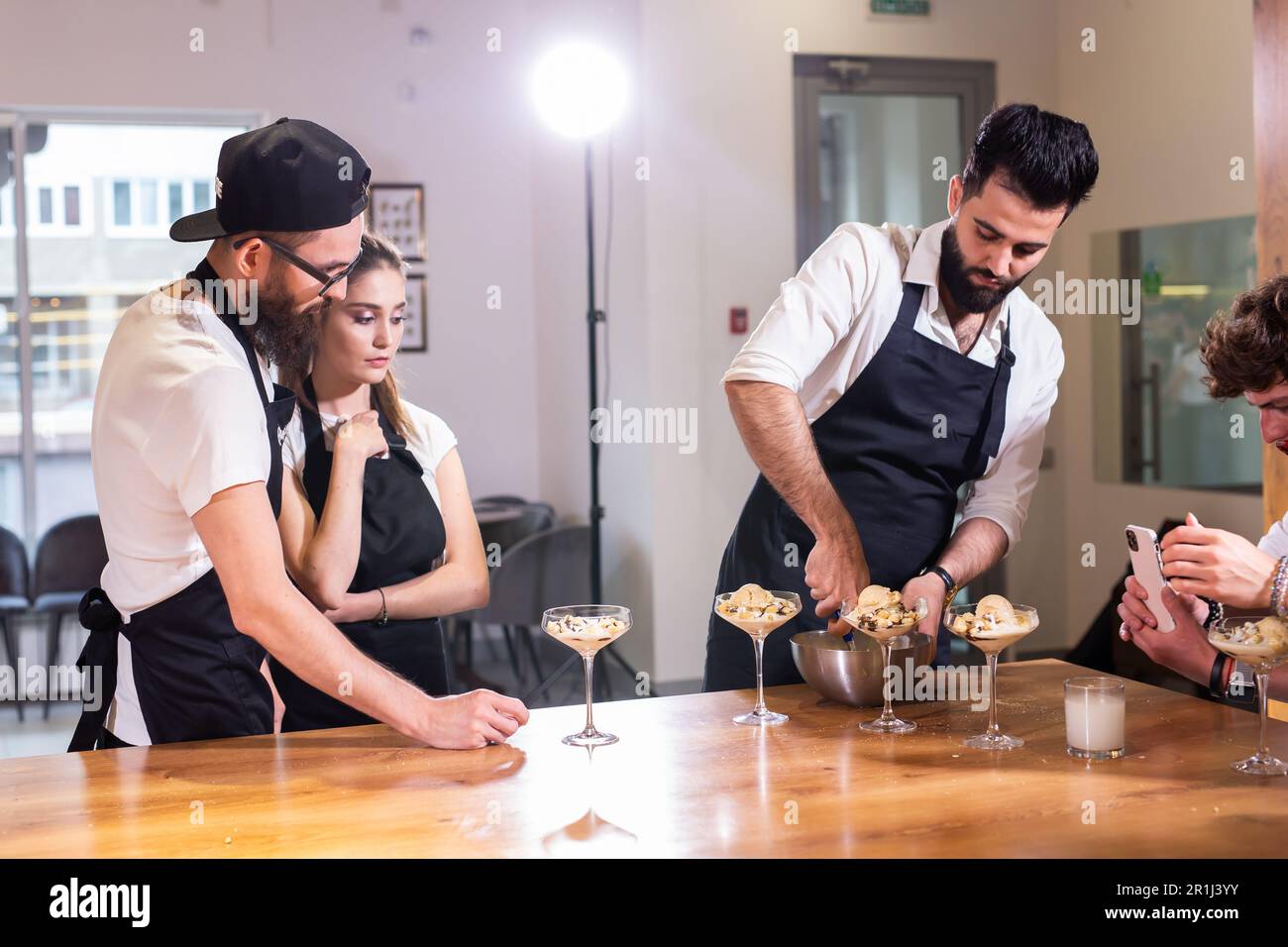 Chef teaching trainees how to make ice cream. Cooking tasty ice cream ...