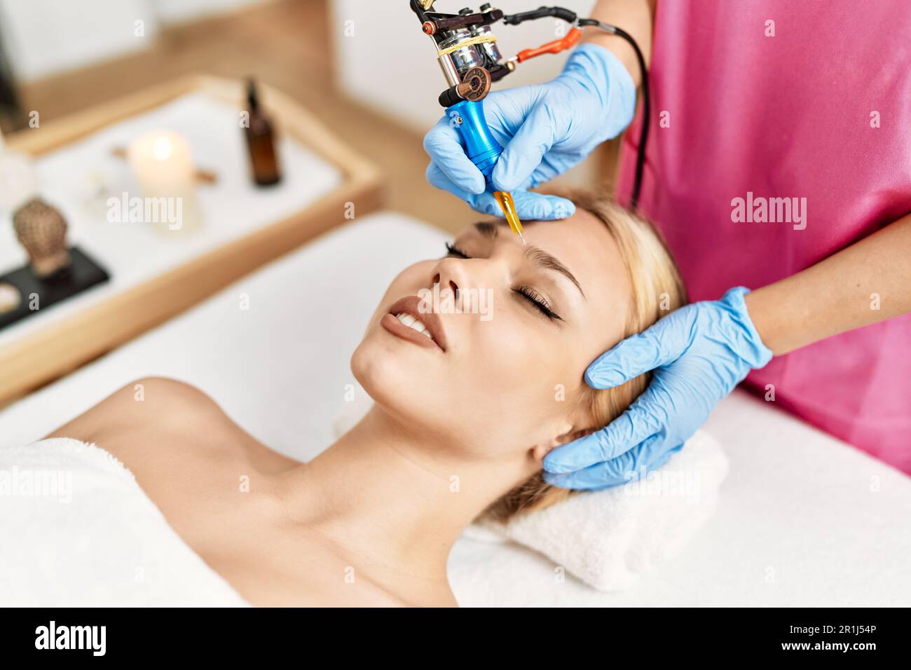 Young caucasian woman lying on table having microblading treatment at ...