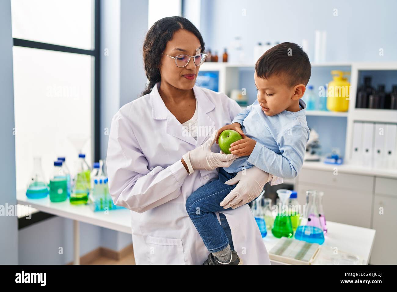 Mother and son wearing scientist uniform hugging each other at ...