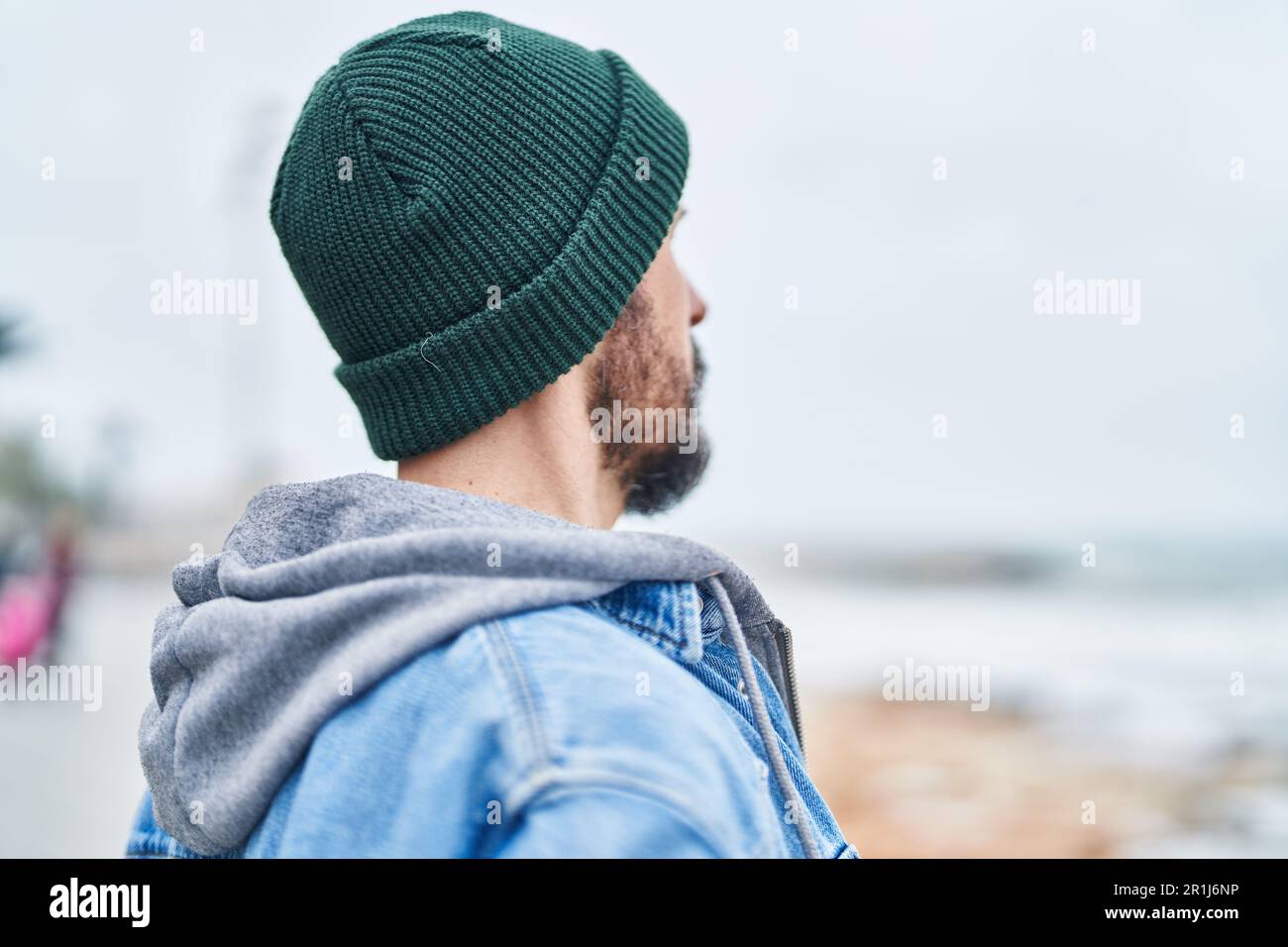 Young bald man standing on back view at seaside Stock Photo - Alamy