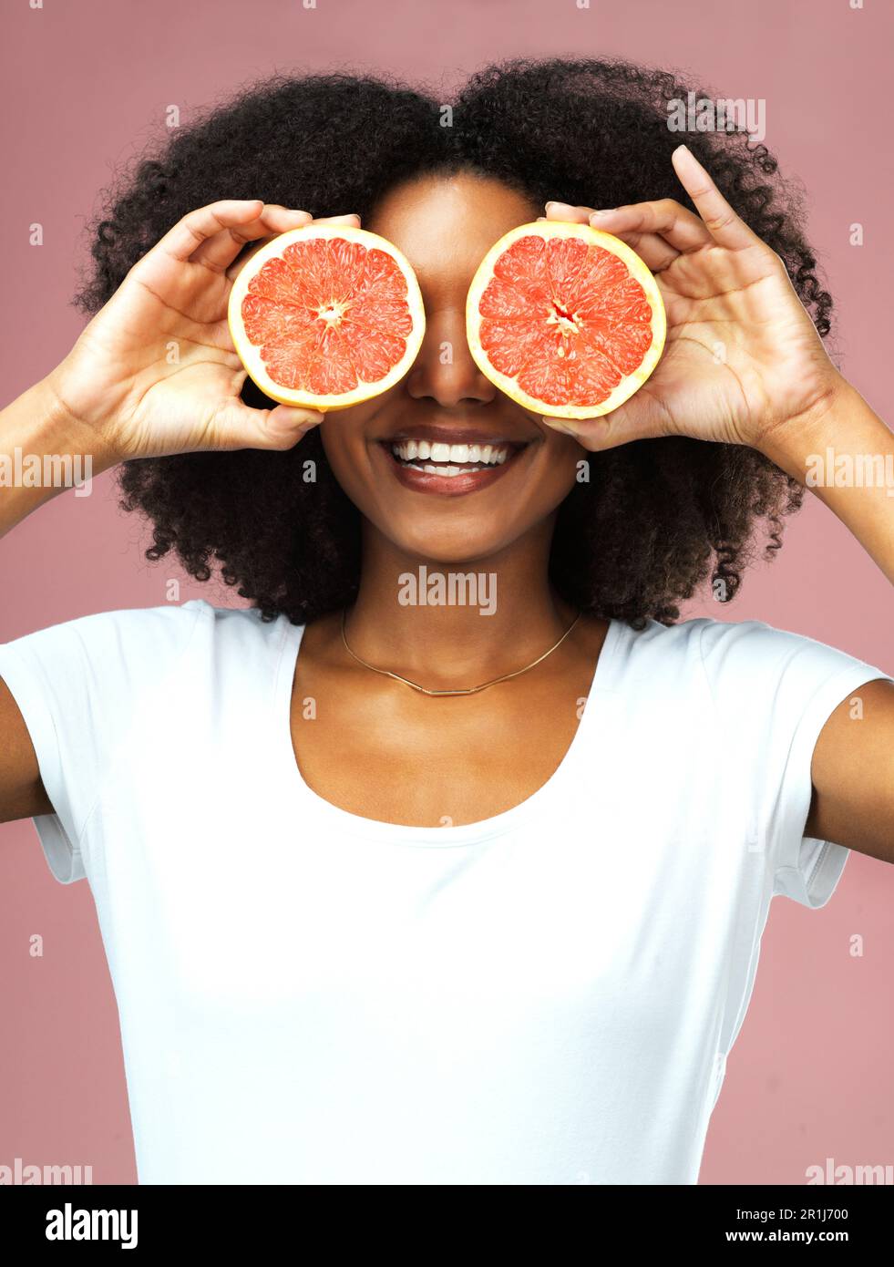 Grapefruit, smile and black woman cover her eyes in studio isolated on ...