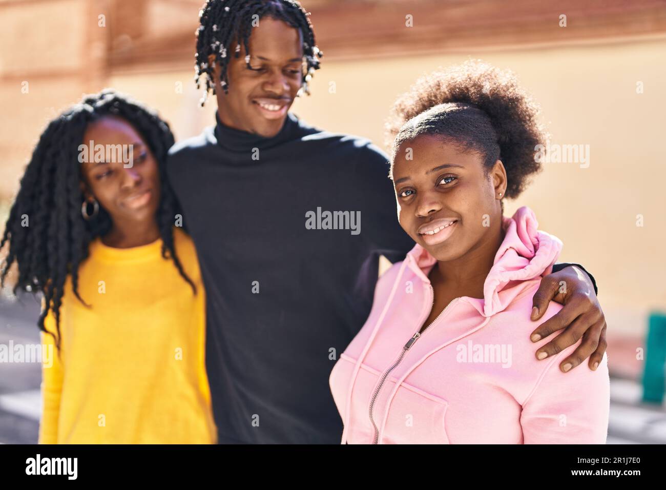 African american friends smiling confident hugging each other at street ...