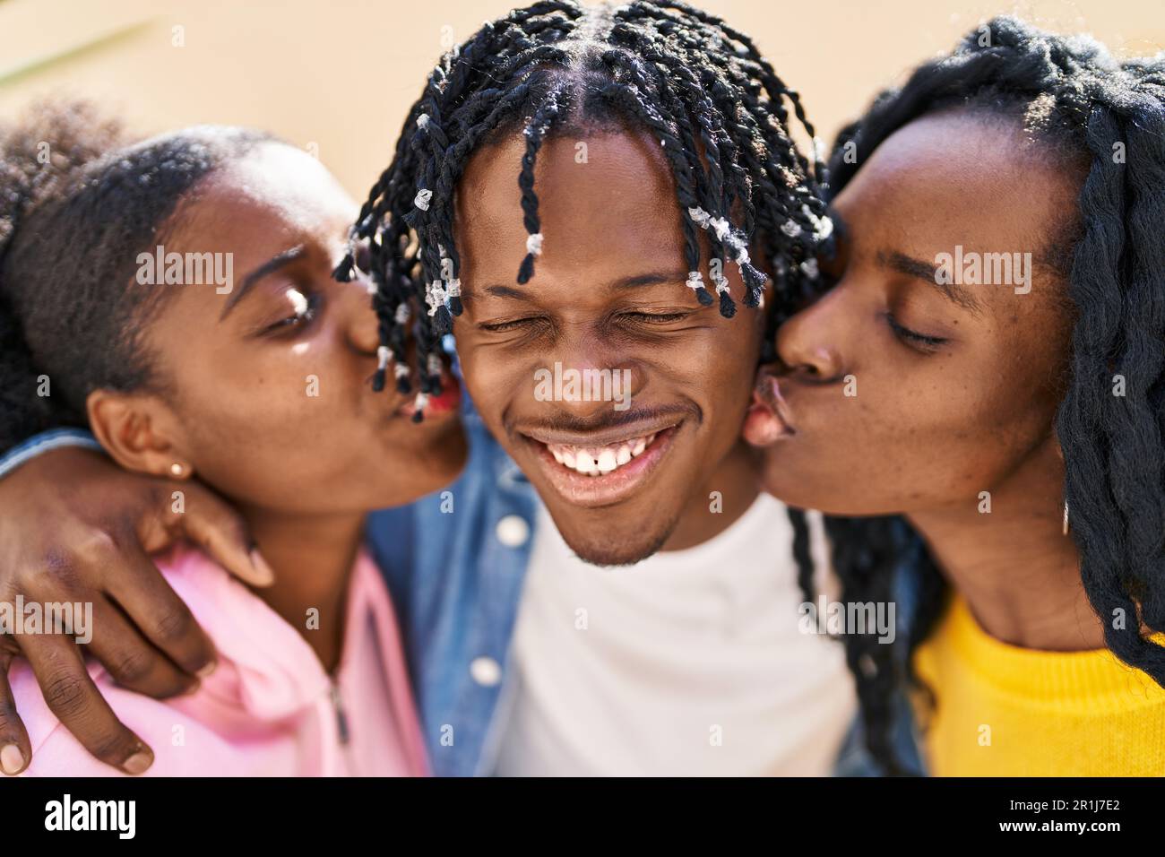 African american friends smiling confident hugging each other kissing ...