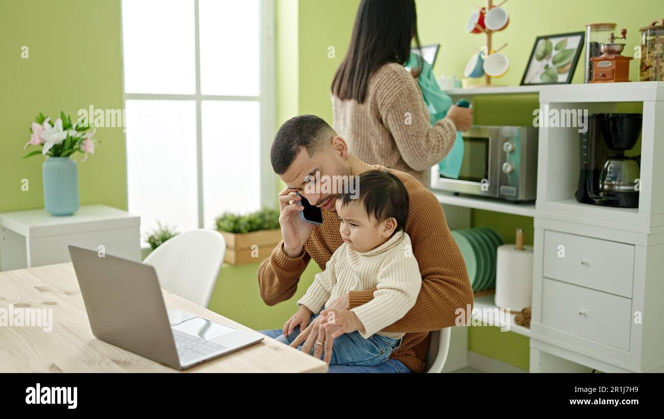 Couple and son taking care of son working at home Stock Photo - Alamy