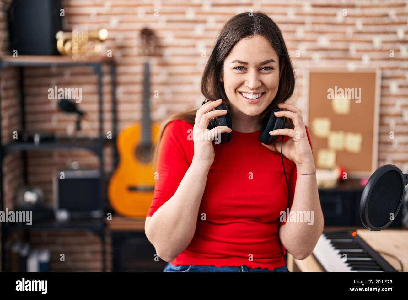 Young woman artist smiling confident at music studio Stock Photo - Alamy