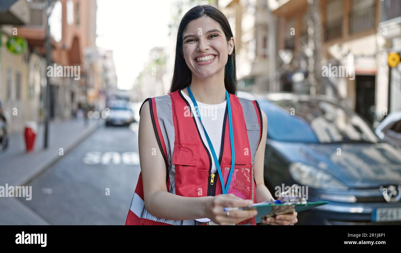 Young beautiful hispanic woman having survey interview writing on ...