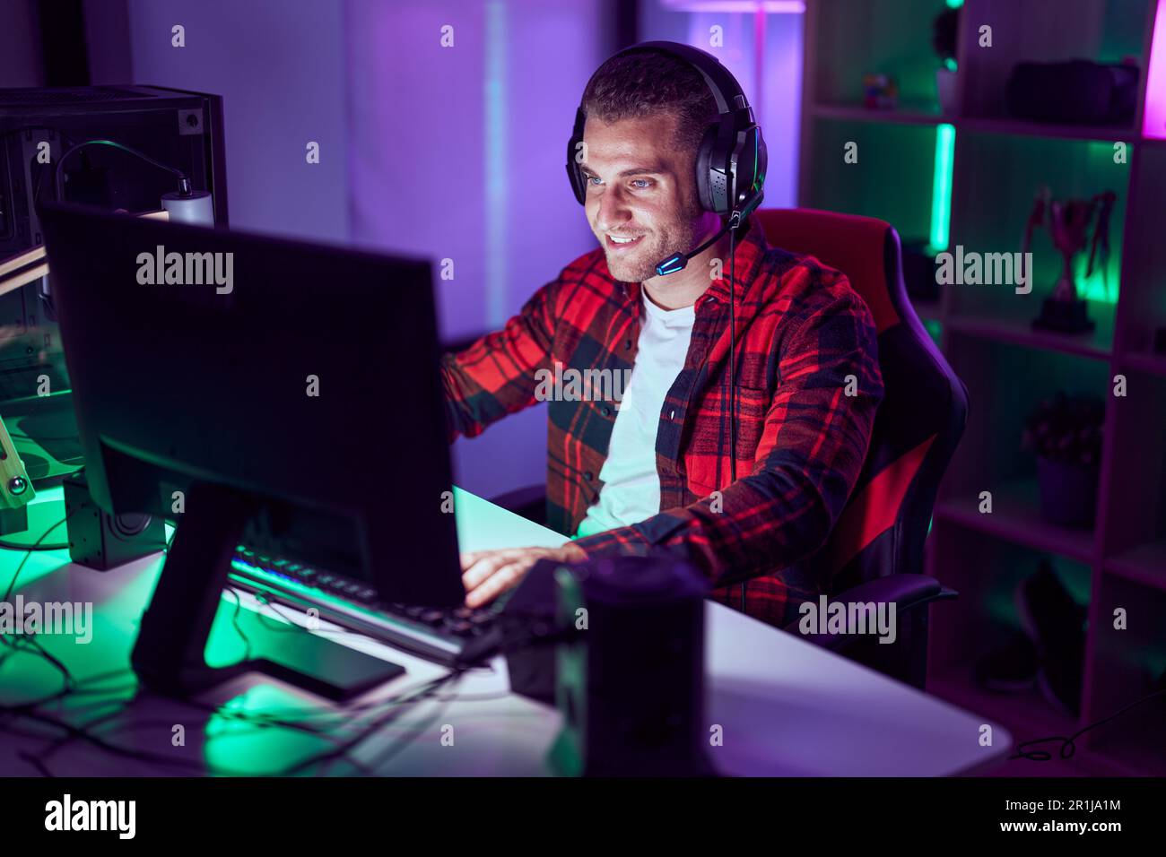 Young caucasian man streamer playing video game using computer at ...