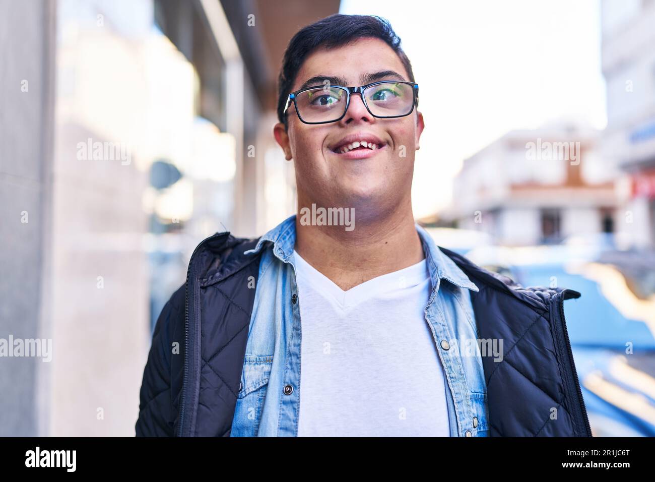 Down syndrome man smiling confident standing at street Stock Photo - Alamy