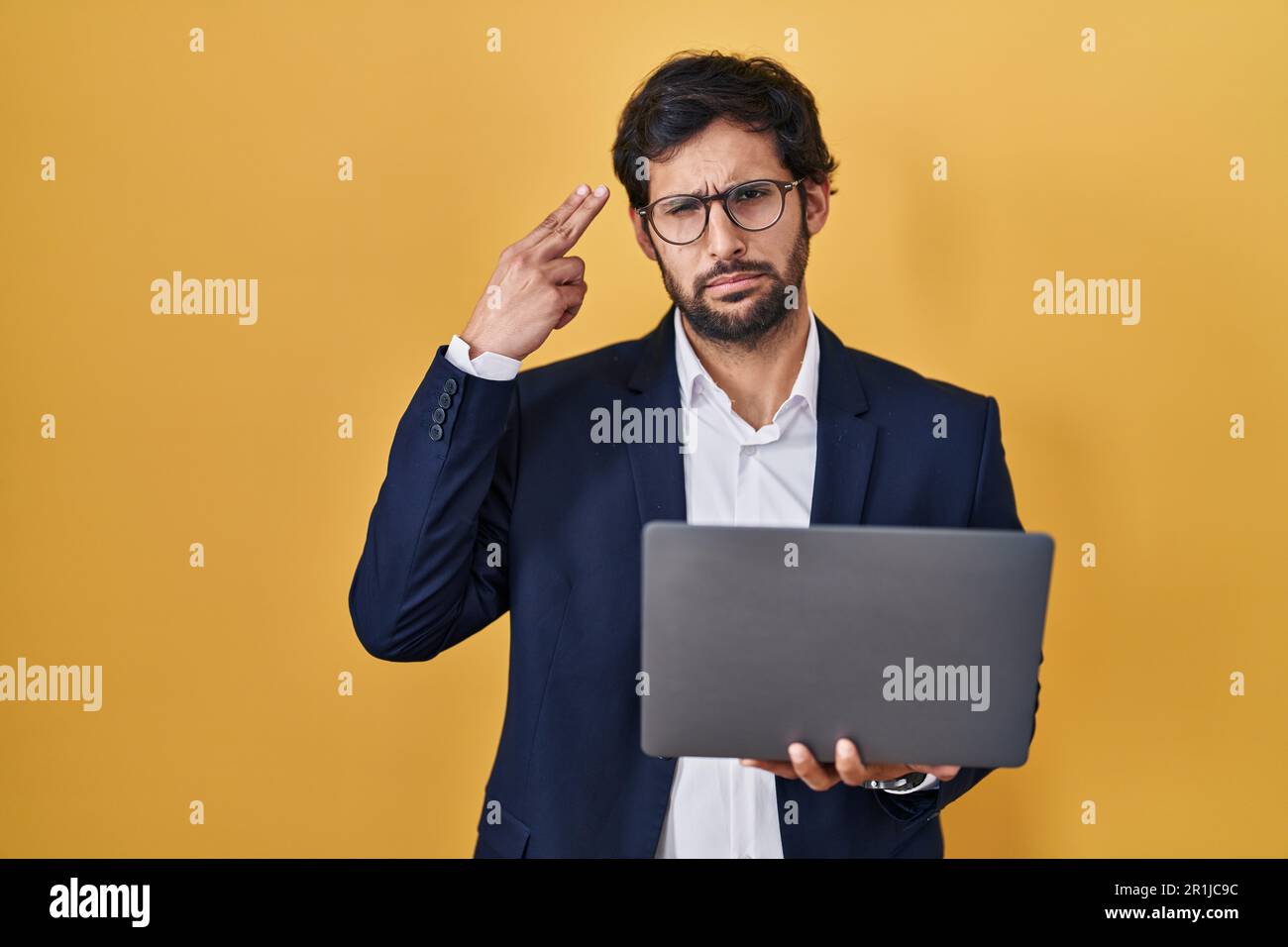 Handsome latin man working using computer laptop shooting and killing ...