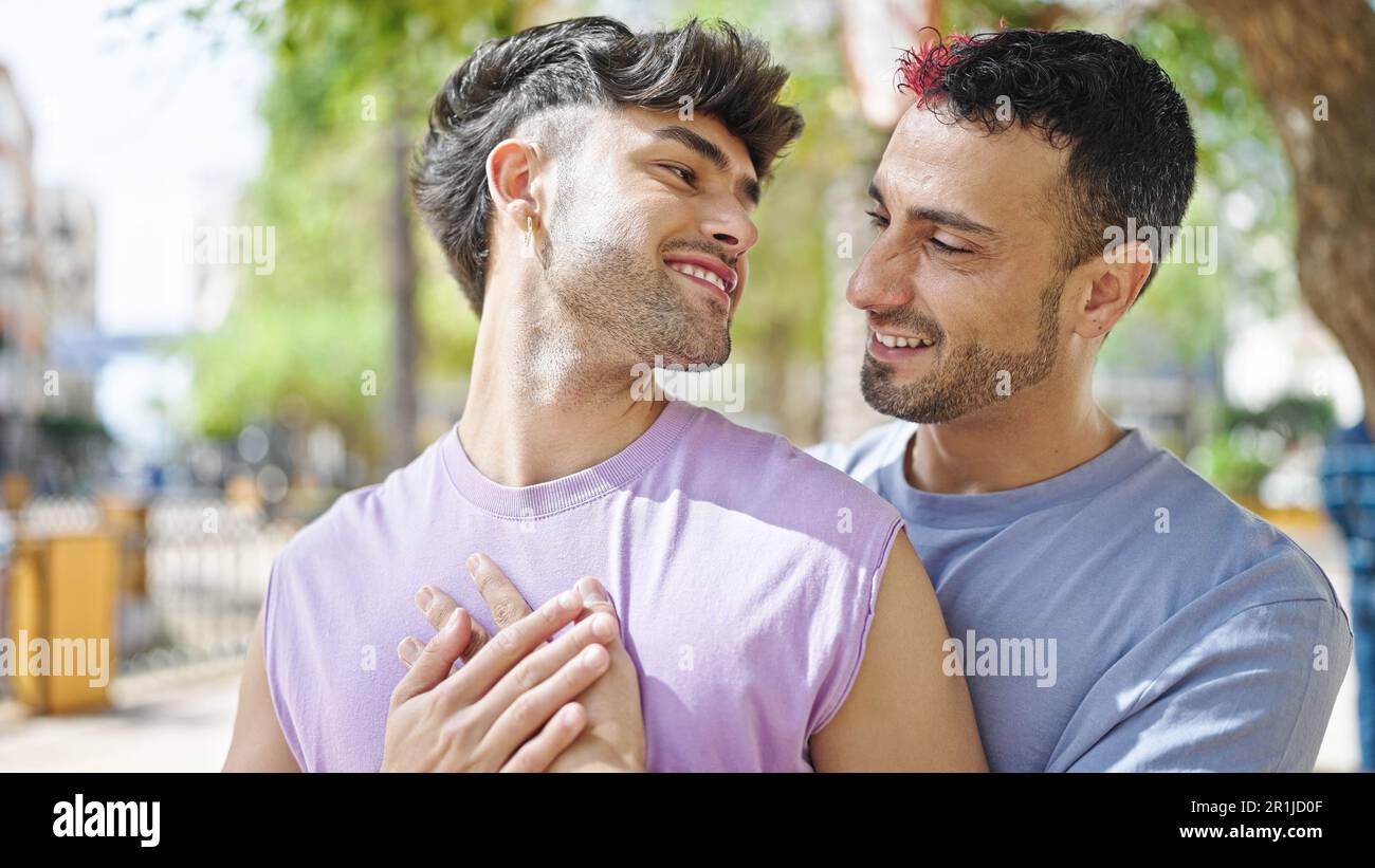 Two men couple smiling confident hugging each other at park Stock Photo ...