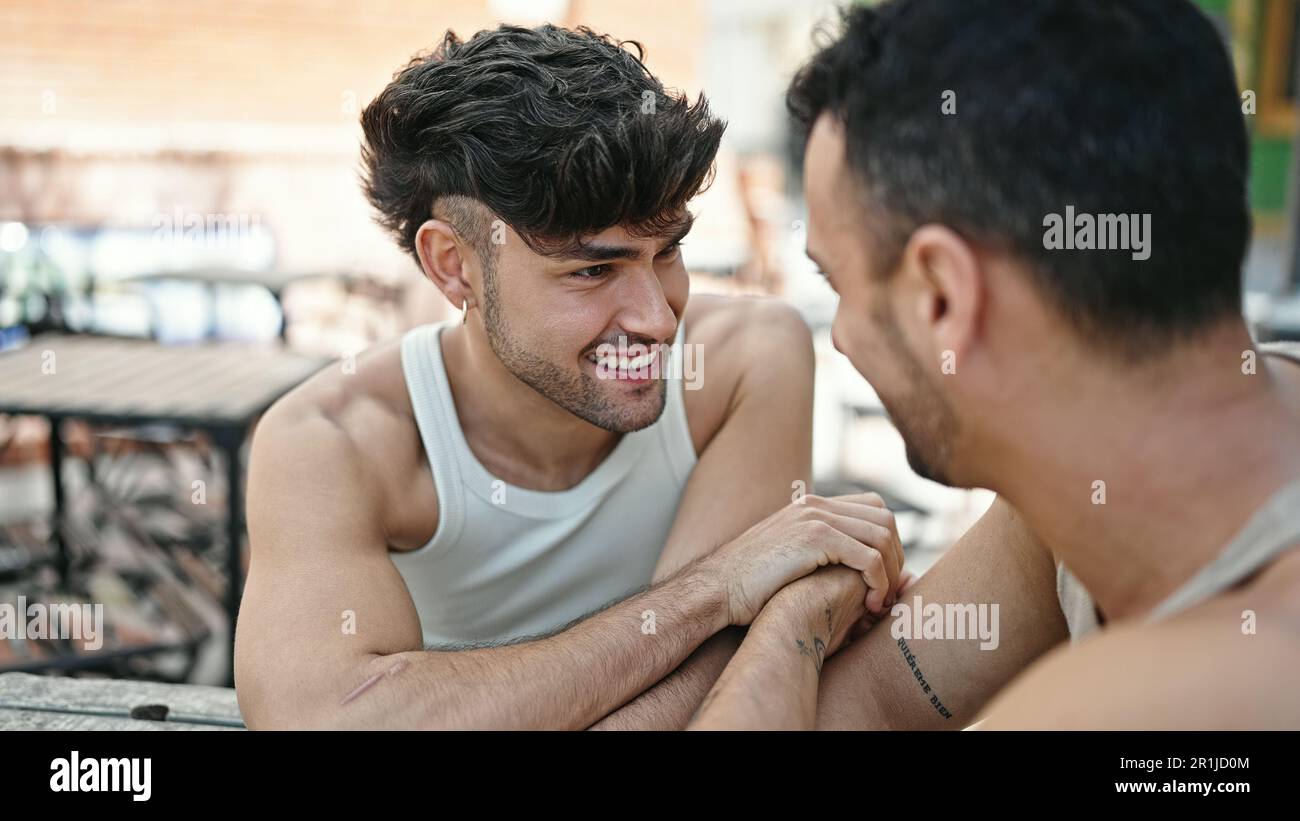 Two men couple sitting on table speaking at coffee shop terrace Stock ...