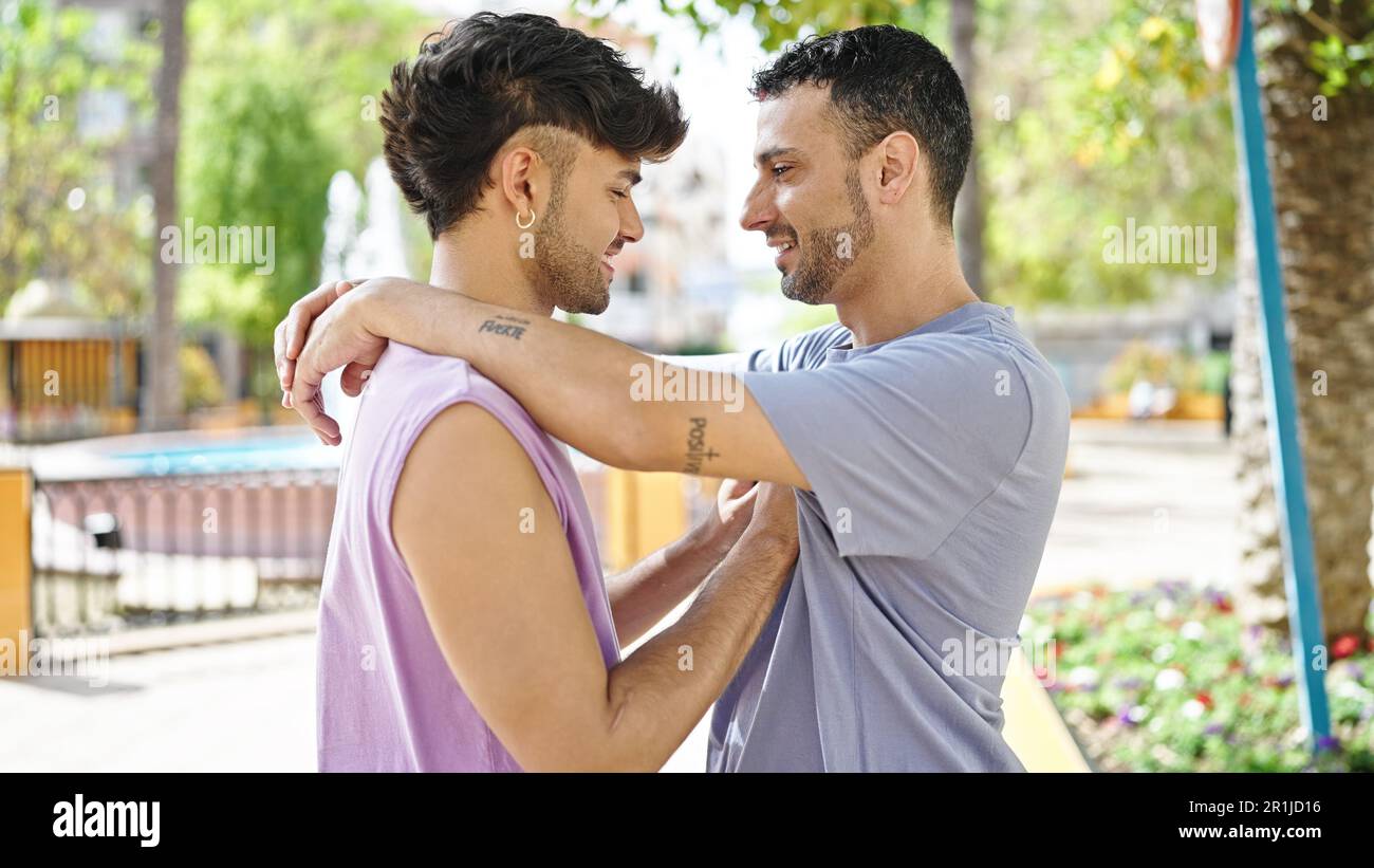Two men couple smiling confident hugging each other at park Stock Photo ...