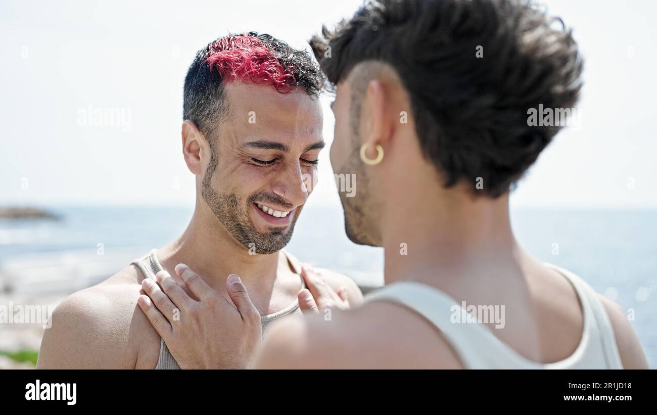 Two men couple smiling confident standing together at seaside Stock ...