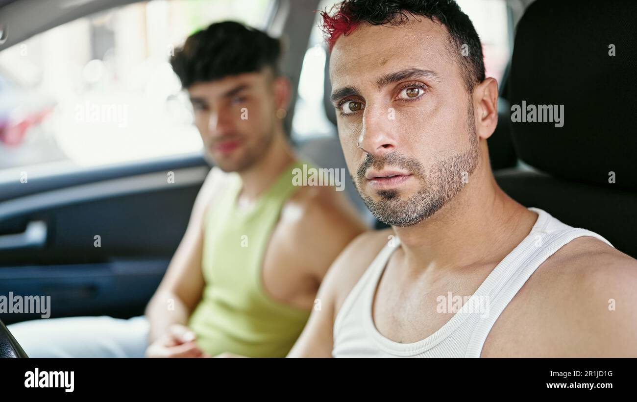 Two men couple driving car at street Stock Photo - Alamy
