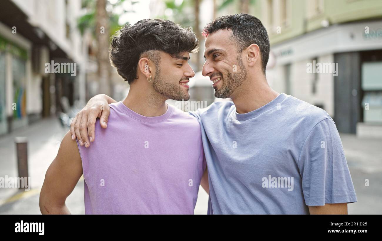 Two men couple smiling confident hugging each other at street Stock ...