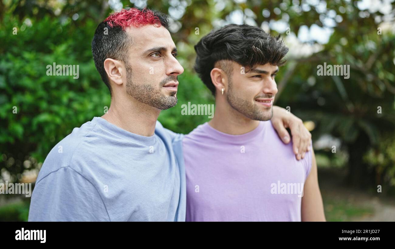 Two men couple smiling confident hugging each other at park Stock Photo ...