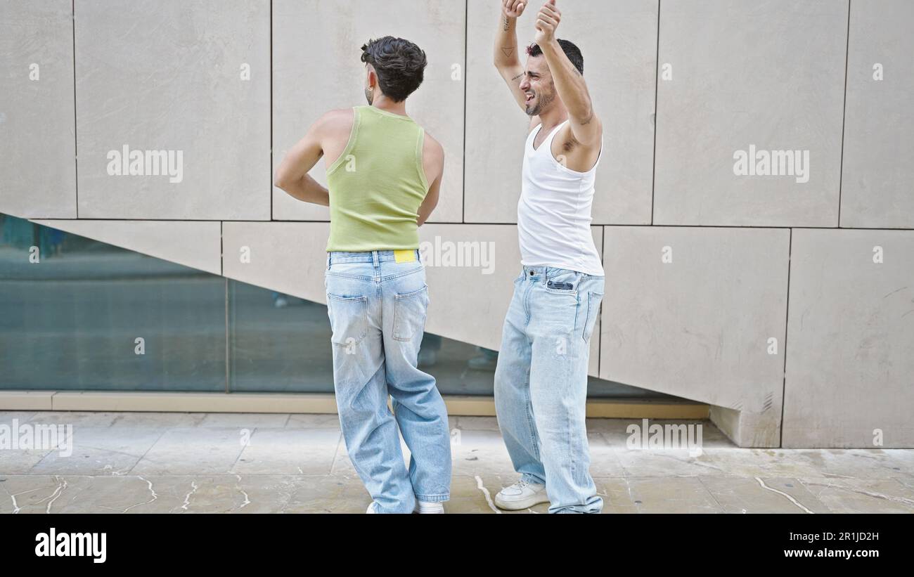 Two men couple smiling confident dancing at street Stock Photo - Alamy