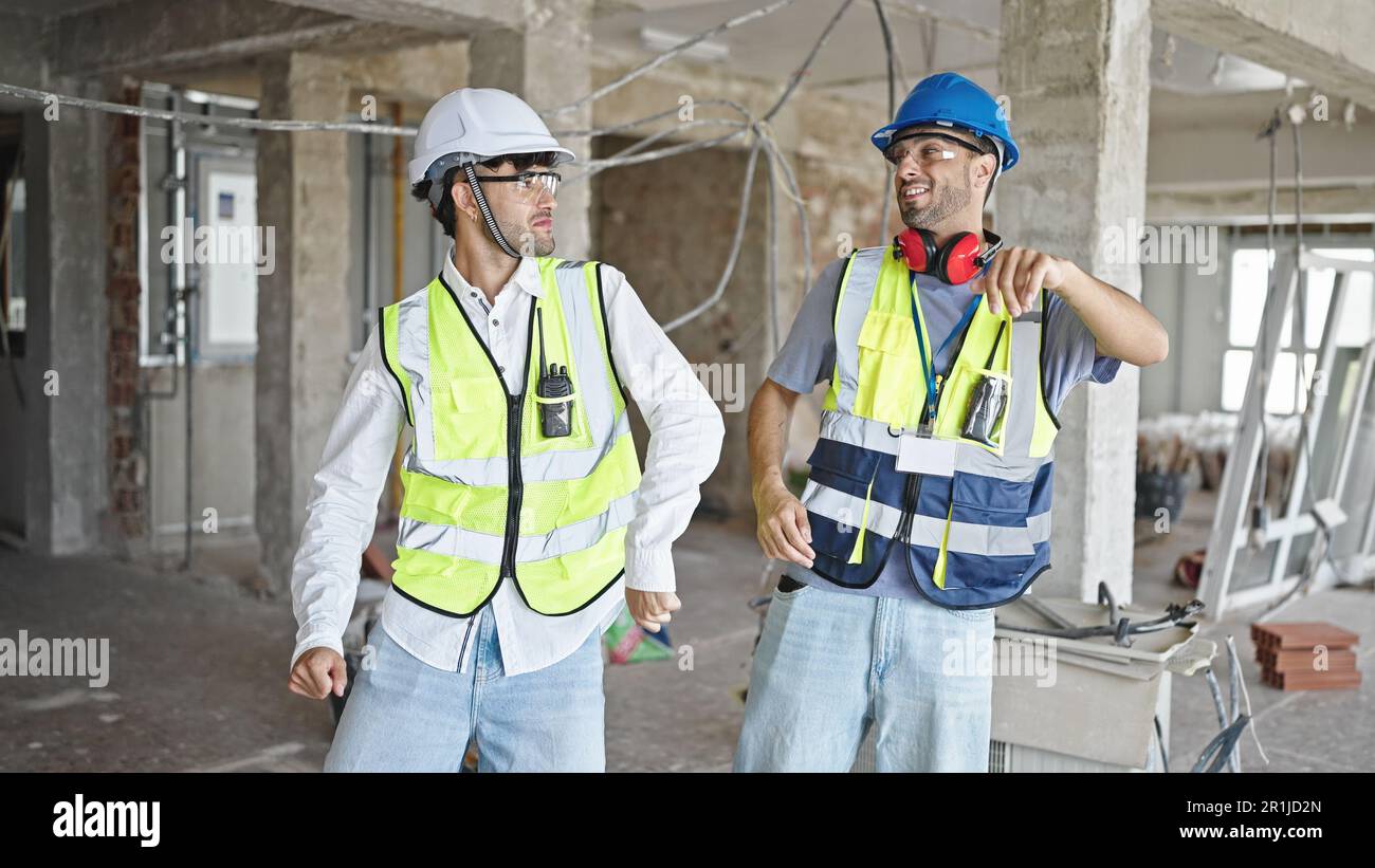 Two men builders smiling confident dancing at construction site Stock ...