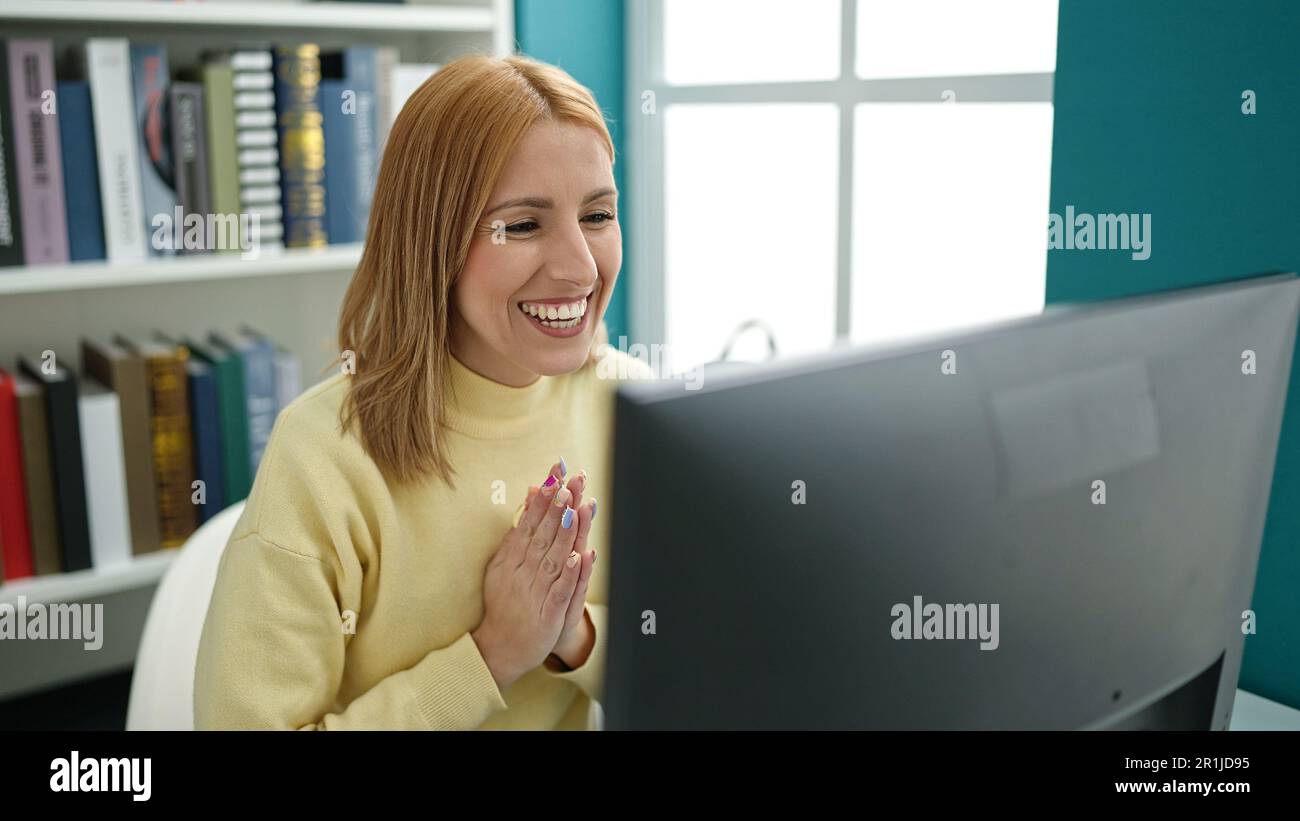 Young blonde woman student smiling confident having video call at ...