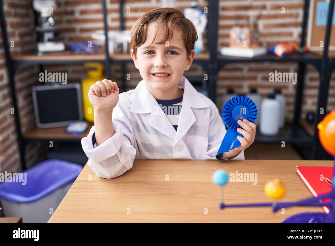 Little caucasian boy at school scientist laboratory winning first prize ...