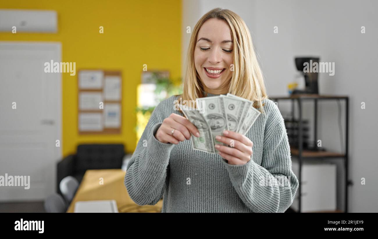 Young blonde woman business worker counting dollars at office Stock ...